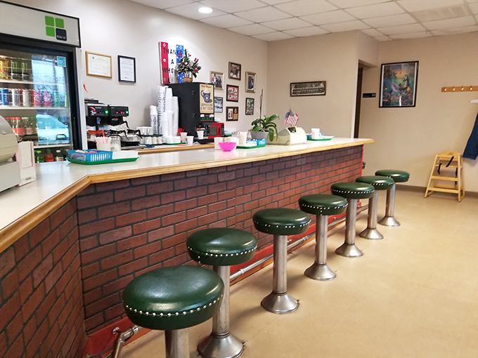 Classic diner-style counter with green vinyl stools&mdash;where donut dreams come true and calories don't count before 10 AM.