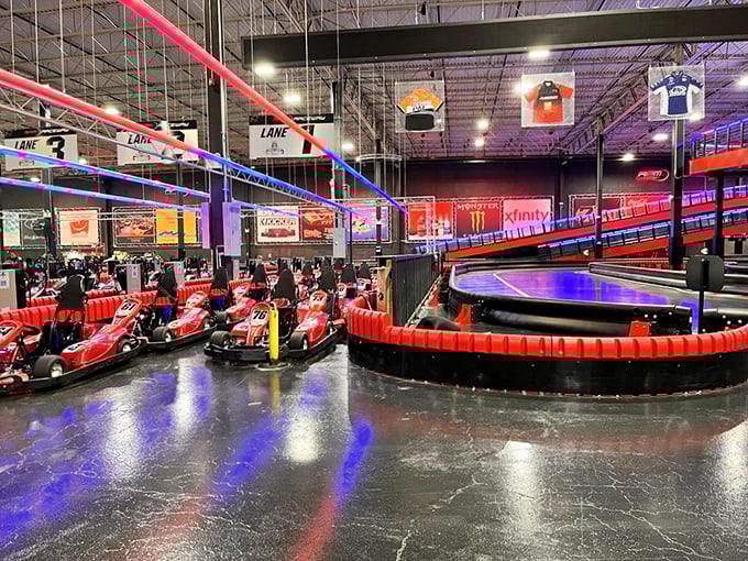 Electric karts line up like eager racehorses at the starting gate, their red frames gleaming under the neon lights of racing glory.
