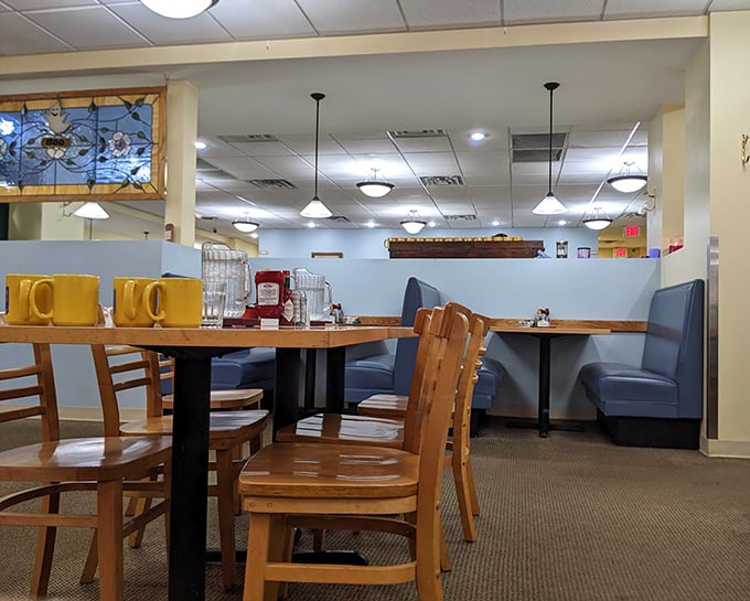 Wooden chairs, blue booths, and stained glass accents create that perfect "I've found my breakfast home" feeling that no trendy brunch spot can manufacture.