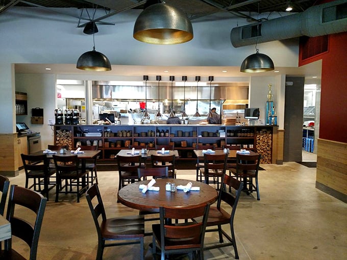 Industrial meets homey in Q39's dining room, where pendant lights cast a golden glow over tables eagerly awaiting their smoky offerings.