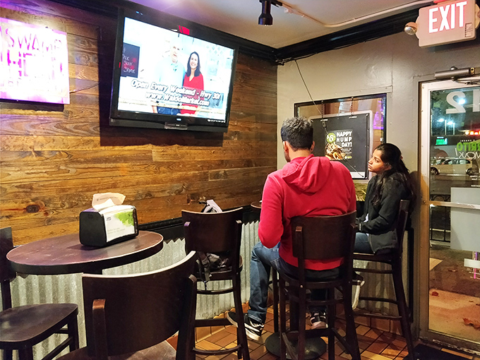 Rustic wood paneling and cozy seating create that perfect "neighborhood joint" vibe where regulars become family and first-timers become regulars.