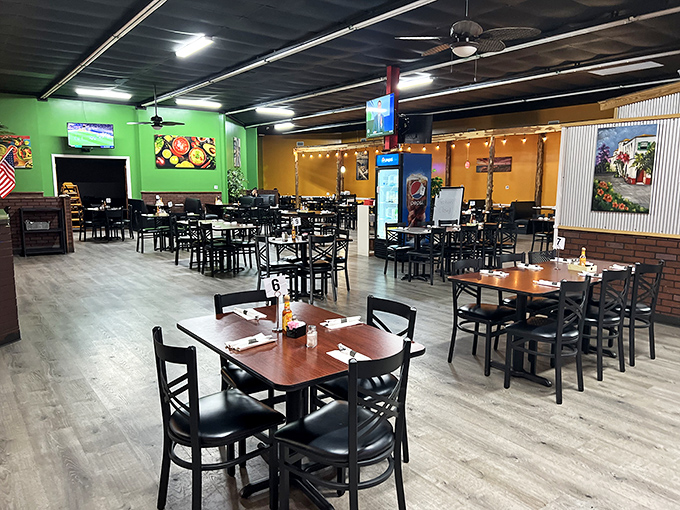 A fiesta for the eyes! Vibrant green and orange walls create distinct dining zones while string lights cast a warm glow that says "relax, you're about to eat something amazing."