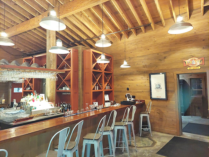 Warm wooden beams meet industrial chic at the bar, where wine racks and pendant lighting create the perfect atmosphere for pre-dinner drinks.