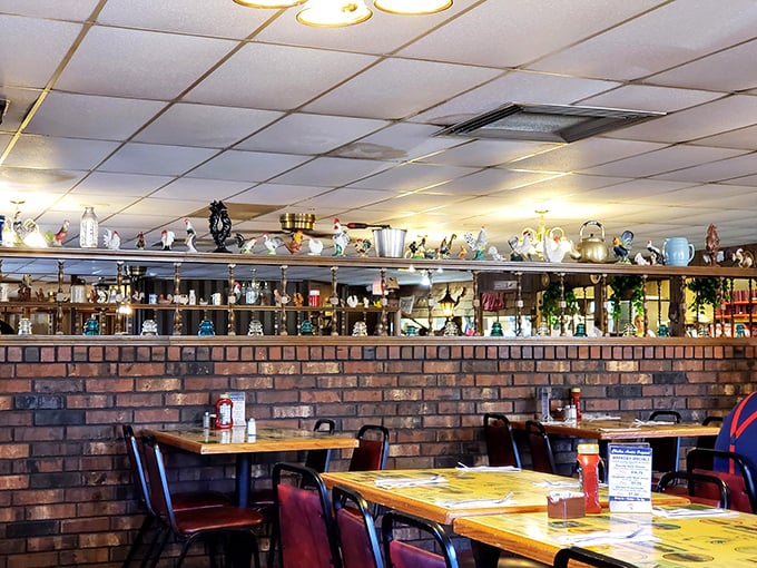 Vintage teapots and collectibles line the shelves above brick walls, creating the homey atmosphere that's been welcoming hungry diners since 1934.
