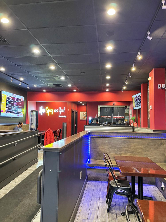 Modern industrial meets fiery comfort inside, where the "How Spicy Are You?" neon sign serves as both question and challenge to newcomers.