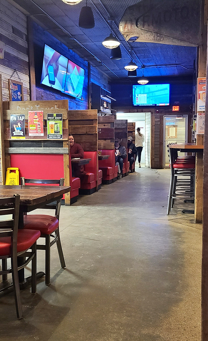 Inside, red booths and industrial lighting create that perfect sweet spot between "trendy enough for Instagram" and "comfortable enough for your grandpa."