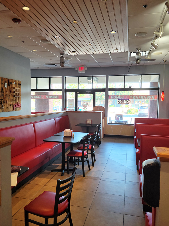 Red vinyl booths that whisper "stay awhile" – the kind of comfortable diner setting where calories don't count and coffee refills flow freely.