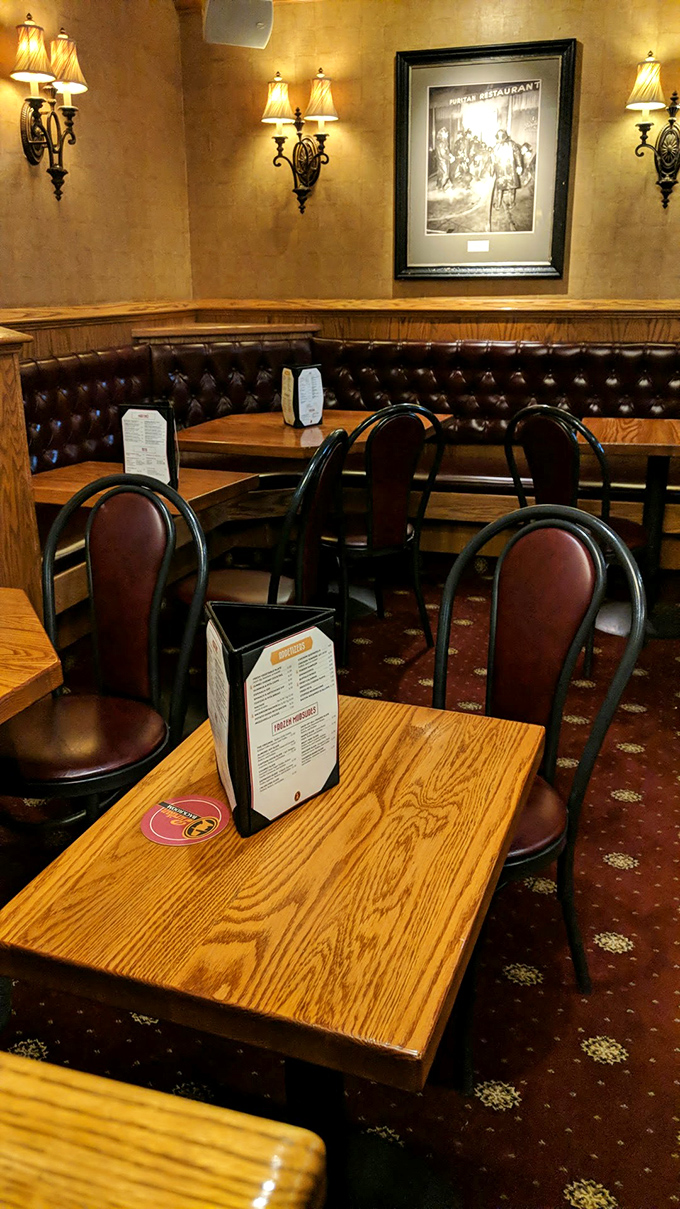 Cozy leather booths and warm lighting create that perfect "everybody knows your name" atmosphere where comfort food memories are born.