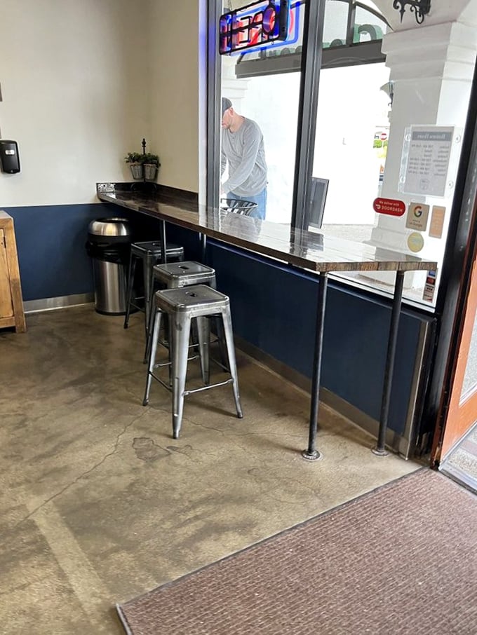 Minimalist interior with industrial charm. The counter where donut dreams come true and coffee conversations flow.