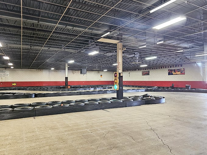 The track stretches before you like a concrete canvas, its tire barriers standing guard, silently daring you to find your perfect racing line.