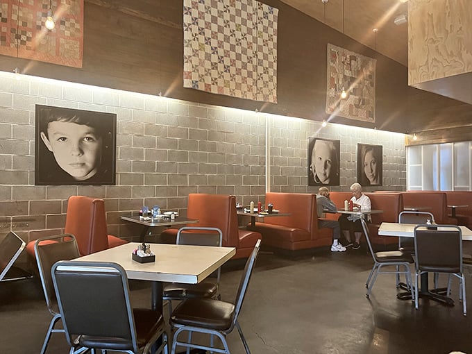 Modern meets homey in this dining space where orange booths invite you to settle in for a feast worth remembering.