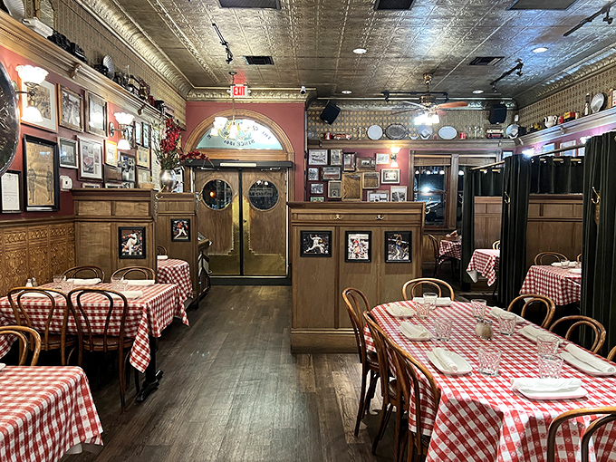 Red-checkered tablecloths and wood-paneled walls tell stories older than your grandparents' first date. History served alongside dinner.