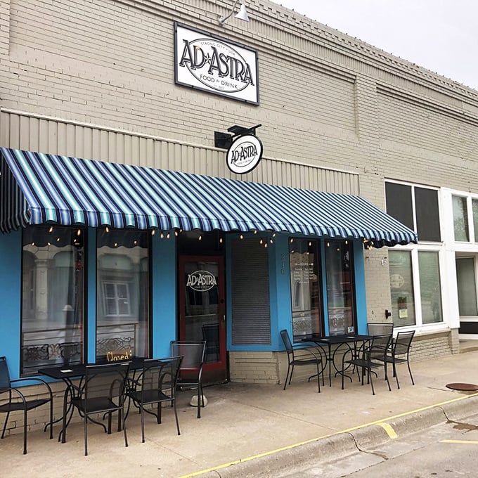 Ad Astra's blue-striped awning and inviting patio beckon hungry travelers like a prairie oasis. The name itself—"to the stars"—promises something celestial.