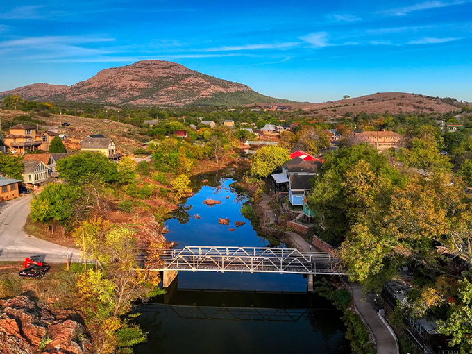 Nature's masterpiece from above &ndash; Medicine Park nestled against the Wichita Mountains with that impossibly blue creek cutting through like a sapphire necklace.