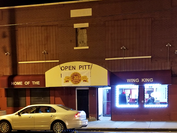 By night, the "Wing King" sign glows with neon promise, a siren call to hungry night owls seeking serious comfort food in Cleveland's east side.