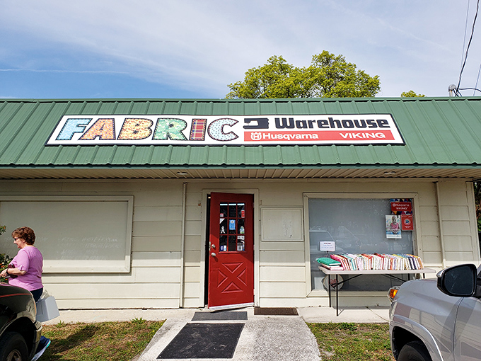 The red door serves as a portal to fabric paradise. Like Alice's rabbit hole, but instead of talking cats, you'll find talking quilters.