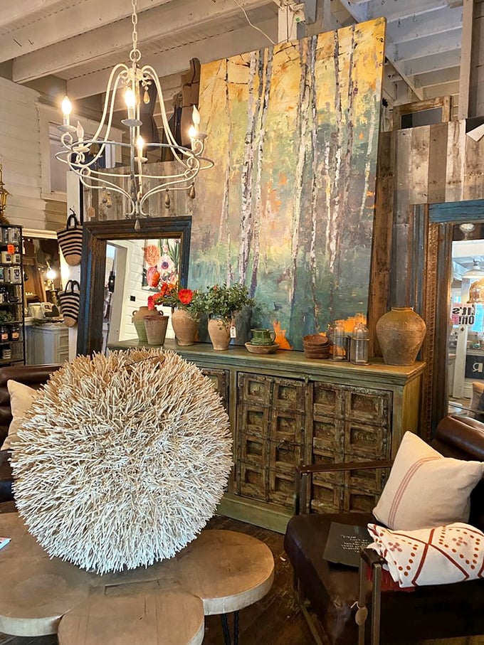 A perfectly styled vignette where rustic meets refined. That textural wall art would make any minimalist rethink their life choices.