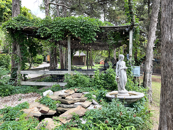 Nature reclaims this garden pergola, creating a serene retreat where statues stand guard over bubbling fountains and secret pathways.
