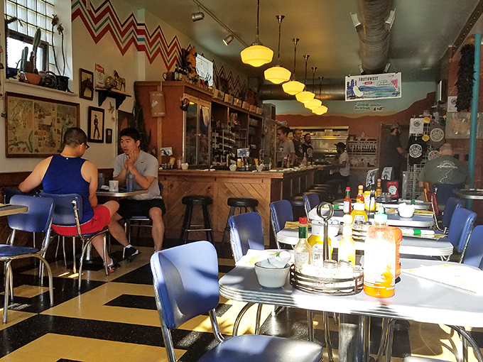 Retro blue chairs, zigzag patterns, and warm pendant lighting create the perfect backdrop for breakfast magic to unfold.