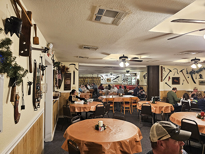 Inside, rustic charm meets comfort with wooden paneling, farm implements, and tables set for families ready to feast together.