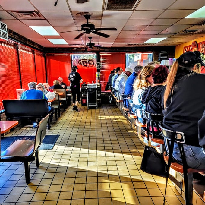 Inside, the no-nonsense interior whispers tales of decades of satisfied diners, with red blinds casting a warm glow over conversations and coffee refills.