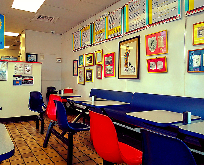 The interior is a time capsule of Americana&mdash;red and blue chairs, simple tables, and walls that tell stories through decades of memorabilia.