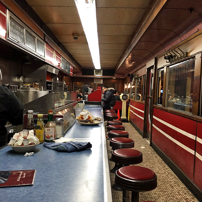 Inside Mickey's, the narrow dining car creates an intimate ballet of servers and diners, where every stool tells a story and every counter inch matters.