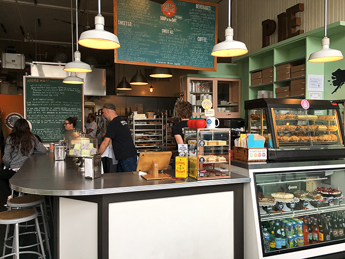 Pie headquarters in full swing! The bustling counter, chalkboard menu, and display cases showcase the serious business of making people happy through pastry.