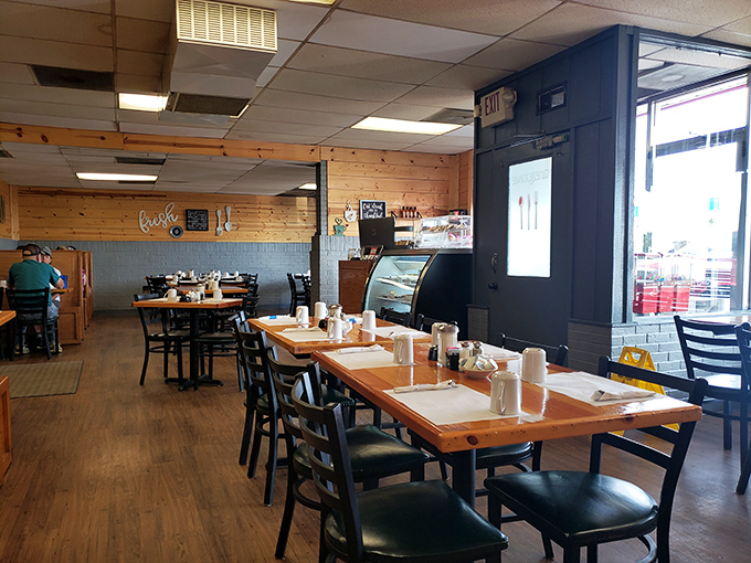 Inside, pine-paneled walls and simple wooden tables create that rare atmosphere where conversations flow as freely as the coffee.