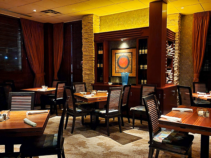 Warm wood, ambient lighting, and thoughtful design create that rare dining space where you could propose or just hide from Tuesday&mdash;both equally welcome.