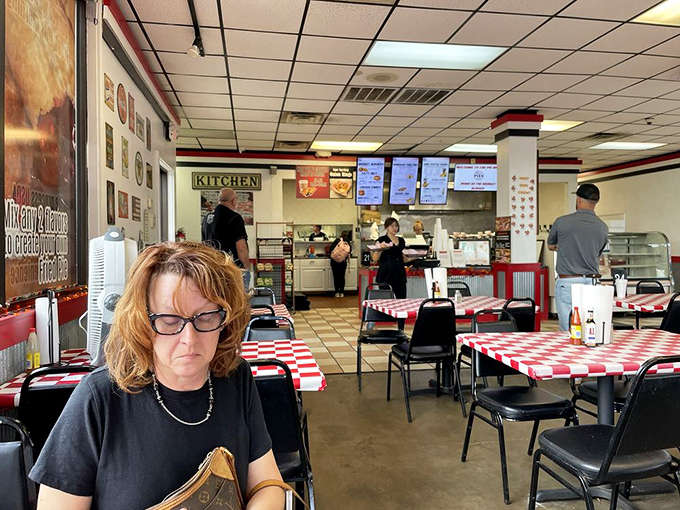 Red and white checkered tablecloths set the stage for comfort food theater, where the main characters are golden-brown pockets of joy.
