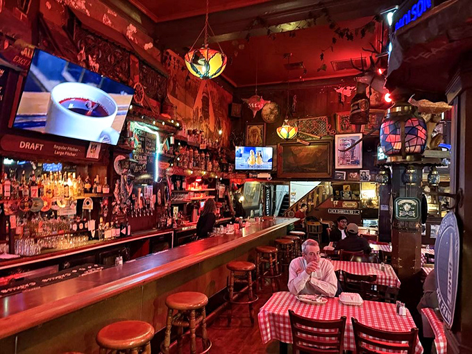 Step inside and you're transported to another era&mdash;where red-hued lighting, checkered tablecloths, and walls adorned with decades of collected curiosities create an atmosphere no designer could replicate.