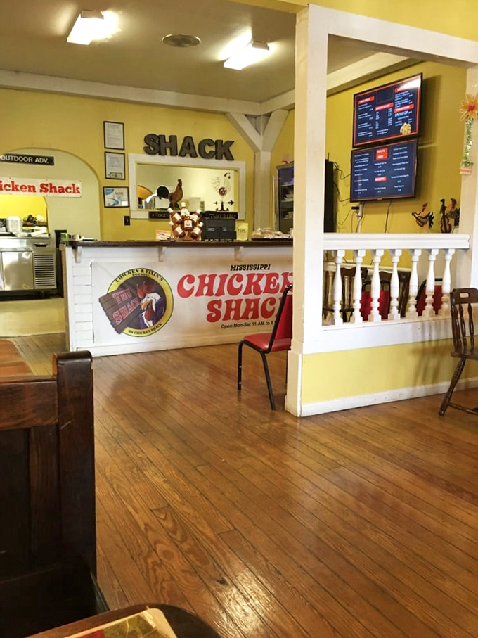 Warm yellow walls and rustic wooden church pews create a homey atmosphere that says, "Stay awhile, the chicken's worth it."