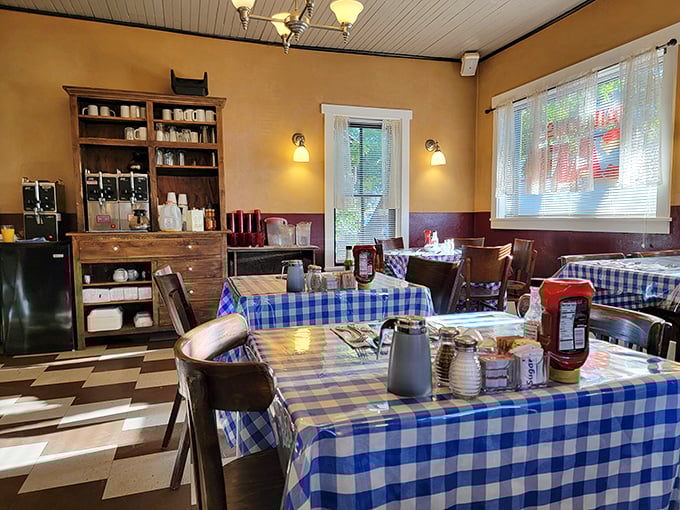 Blue checkered tablecloths and warm wooden accents create the perfect crime scene for breakfast indulgence&mdash;no alibi needed for returning daily.