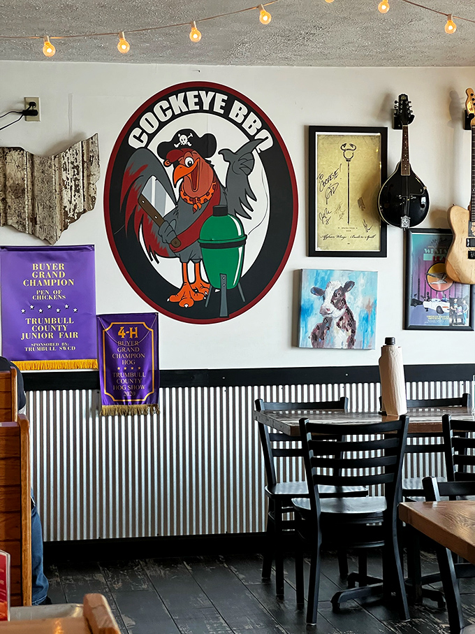 That pirate rooster logo isn't just cute&mdash;it's a promise of rebelliously good barbecue in a space where 4-H ribbons and guitars share wall space.