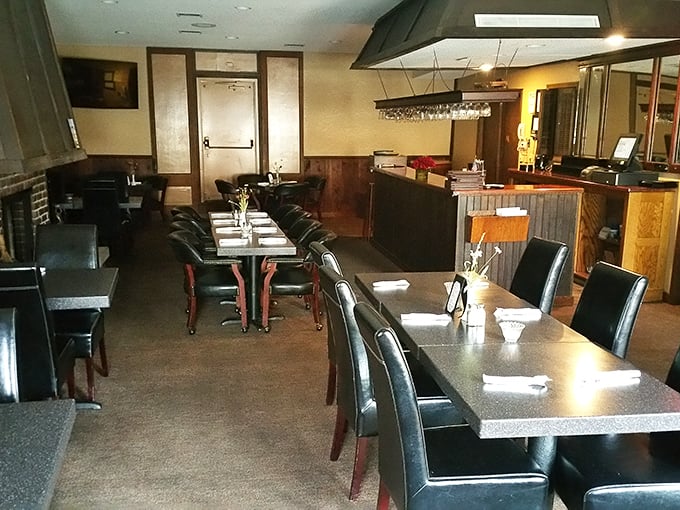 Inside, modern comfort meets historical charm with sleek tables and warm wood accents creating an atmosphere where conversations flow as freely as the coffee.