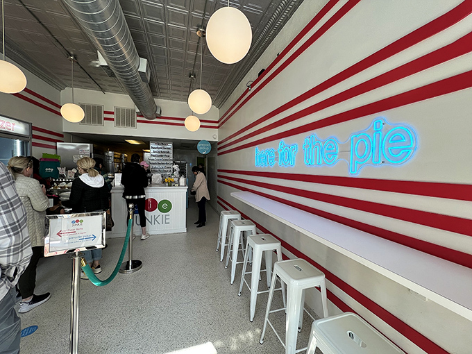 Inside, the neon "here for the pie" sign isn't just decoration&mdash;it's the universal truth that unites everyone in line.