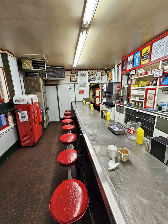 Eight red stools, one long counter, and decades of stories. This narrow diner packs more character per square inch than most restaurants do in their entire space.