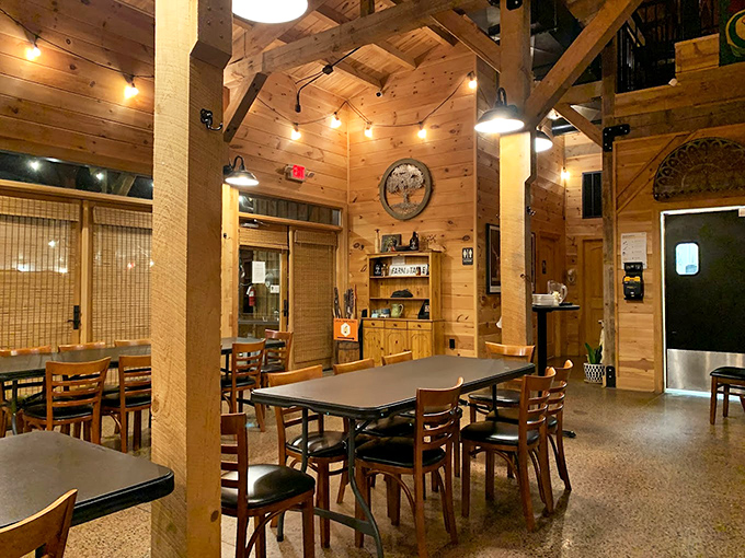 Exposed beams, string lights, and wooden charm create an atmosphere that feels like a warm hug from your favorite aunt.