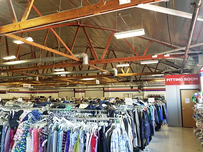 Endless racks stretch toward industrial rafters, creating a textile galaxy where fashion from every decade awaits its second chance at stardom.