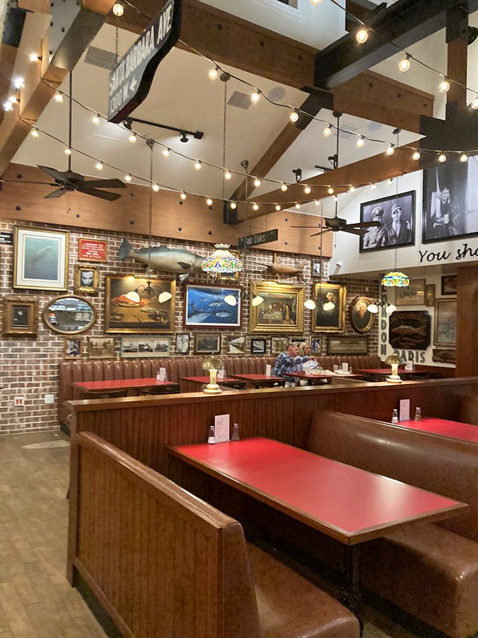 Nautical memorabilia explosion meets cozy wooden booths. It's like dining inside a sea captain's prized collection, with string lights for ambiance.