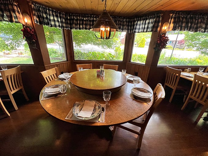 Round tables and checkered curtains create that rare dining atmosphere where strangers become friends over shared platters of Southern goodness.