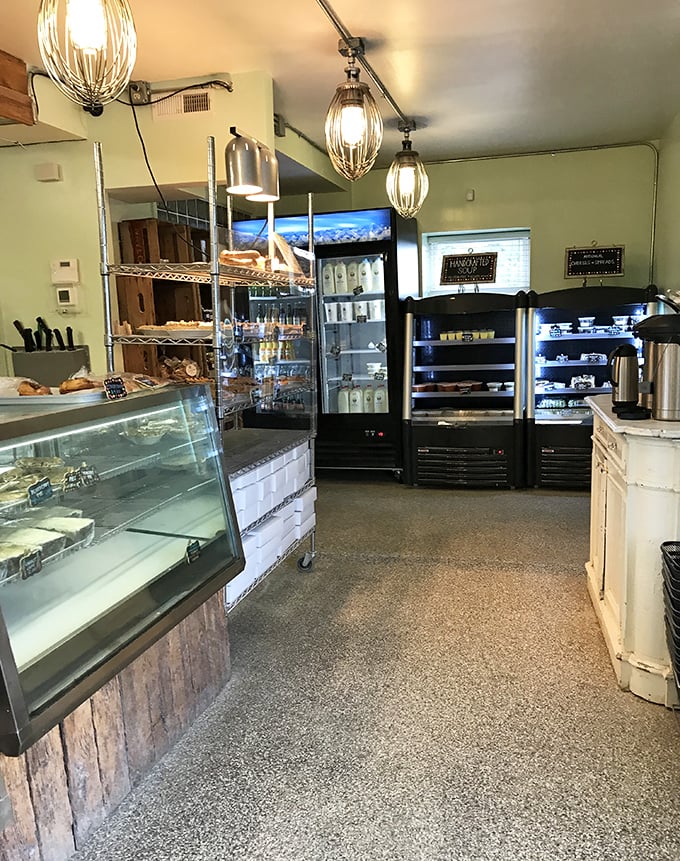 Industrial-chic meets warm bakery vibes in this thoughtfully designed space. Those mixer-whisk light fixtures are the kind of clever touch that makes design nerds swoon.