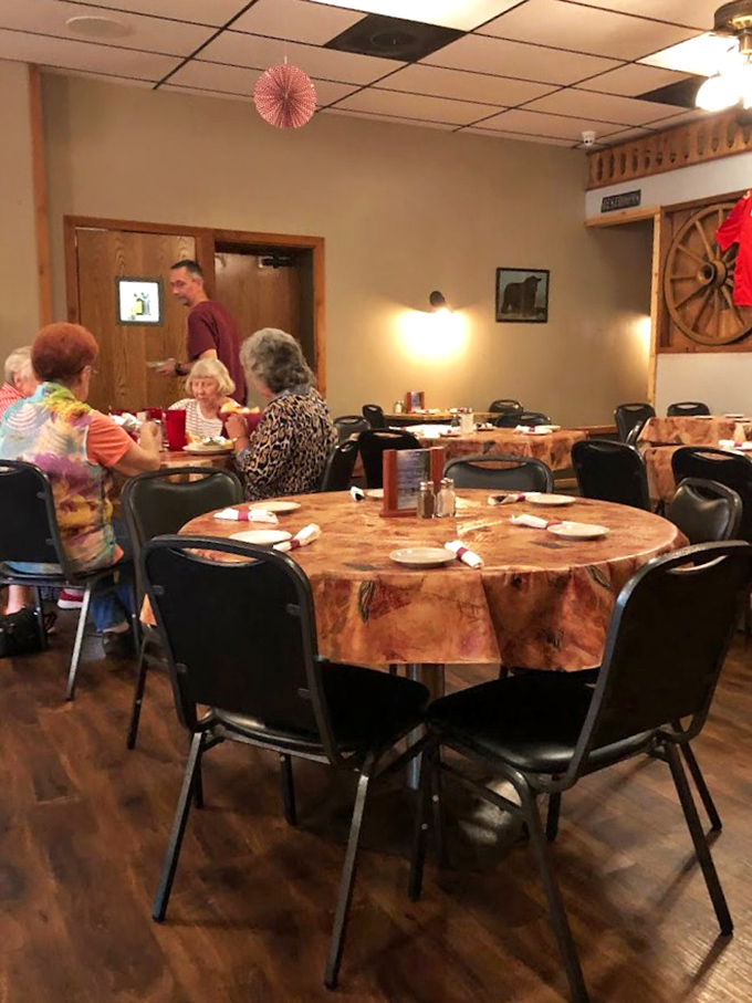 Rustic wooden tables adorned with patterned cloths create an unpretentious dining room where conversations flow as freely as the gravy.