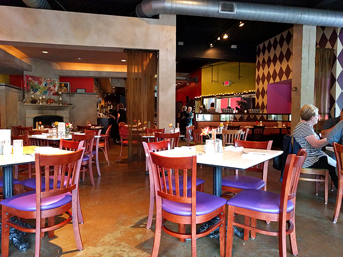 Whimsical harlequin patterns and vibrant reds create a dining space that feels both sophisticated and playful, like Willy Wonka designed a French bistro.