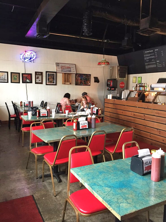 Retro turquoise tables and cherry-red chairs set the stage for barbecue theater&mdash;no fancy tablecloths required when the food's this good.