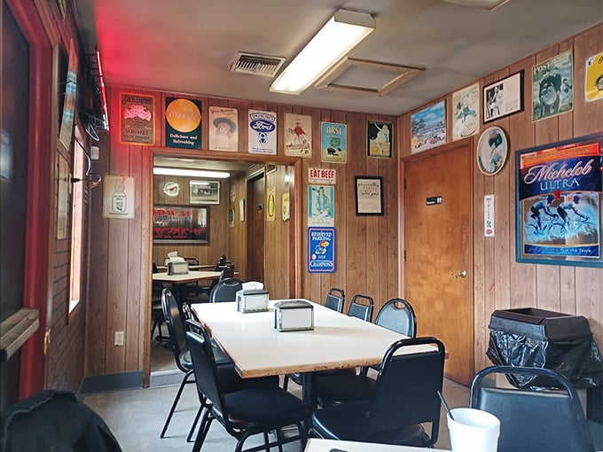 Wood-paneled walls adorned with vintage beer signs create that perfect "we've-been-here-forever" atmosphere that always signals exceptional barbecue.