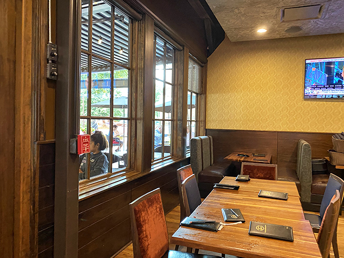 Warm wood tones and golden walls create that perfect "fancy but not too fancy" atmosphere where both date night and Tuesday lunch feel equally at home.