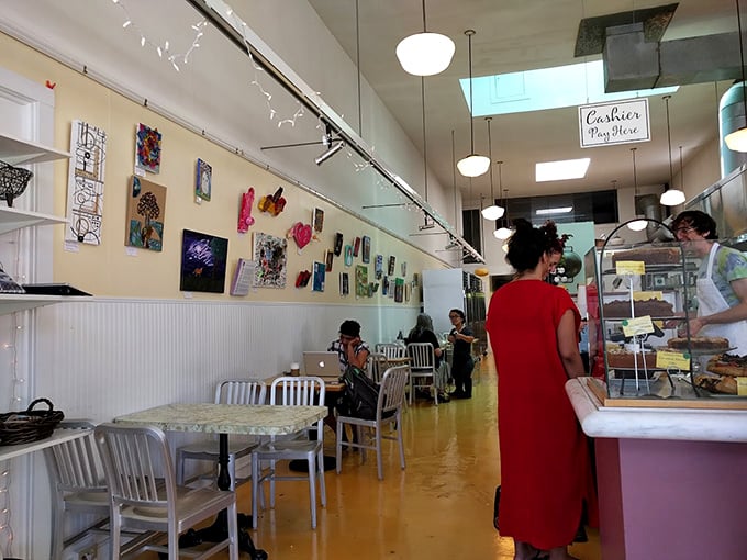 Inside, sunlight dances across the yellow floor while local art adorns cream-colored walls, creating the perfect backdrop for life-changing dessert decisions.