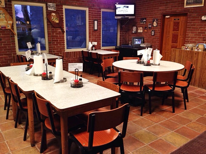 Inside, formica tables and wooden chairs create a time capsule where generations of families have shared perfect pizza moments.